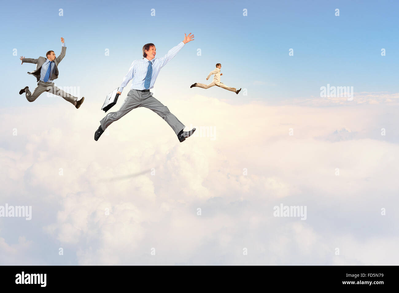 Image of happy business people jumping high in sky Stock Photo - Alamy