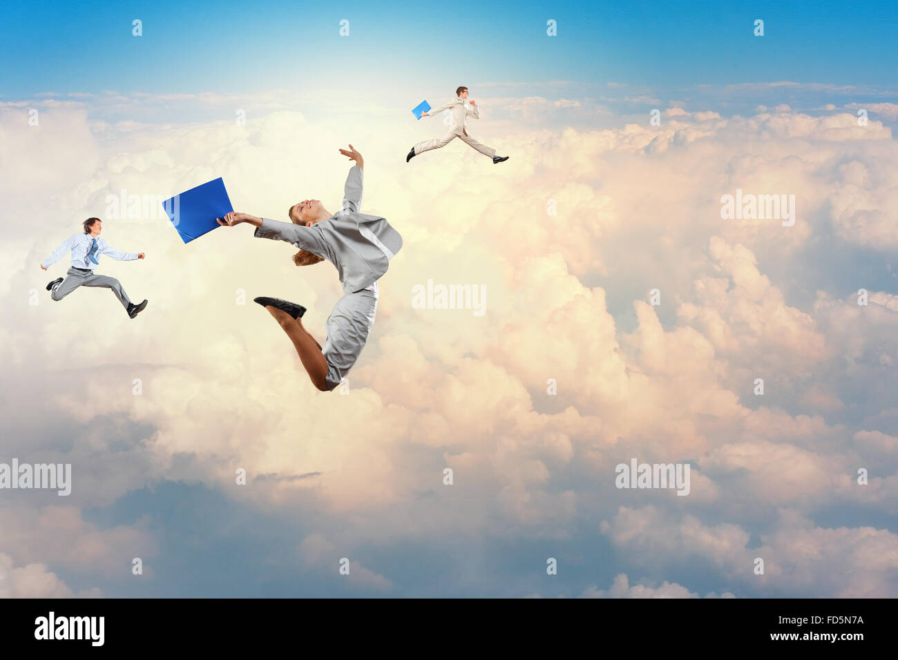 Image of happy business people jumping high in sky Stock Photo - Alamy