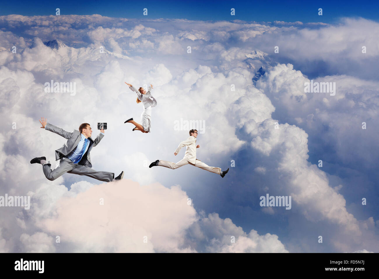 Image of happy business people jumping high in sky Stock Photo - Alamy