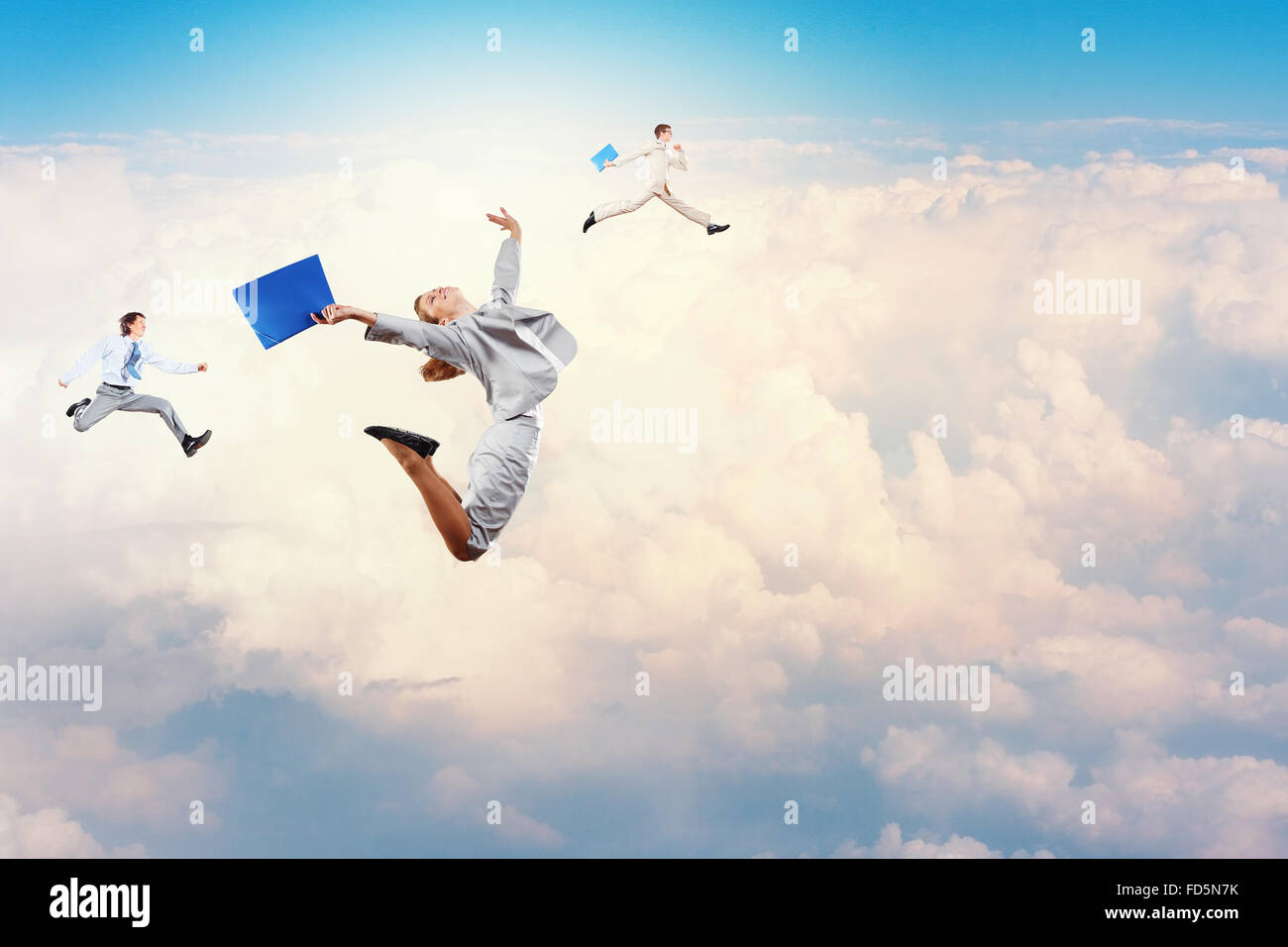 Image of happy business people jumping high in sky Stock Photo - Alamy