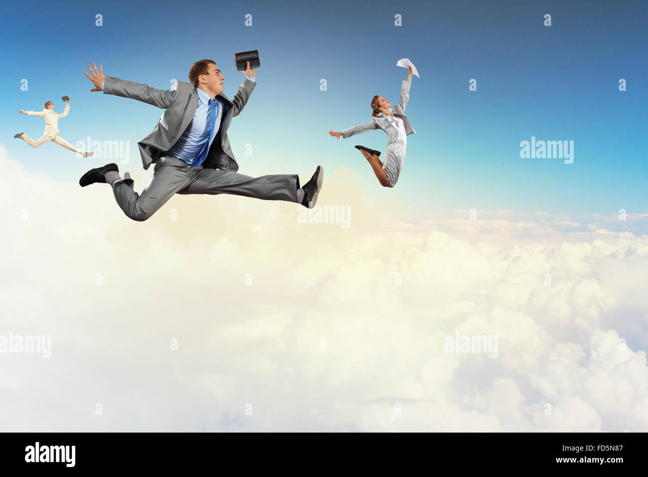 Image of happy business people jumping high in sky Stock Photo - Alamy
