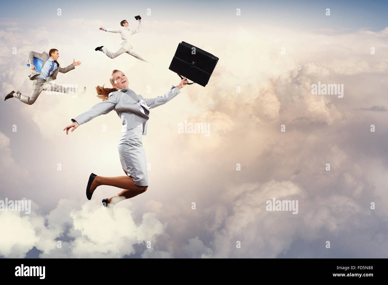 Image of happy business people jumping high in sky Stock Photo - Alamy