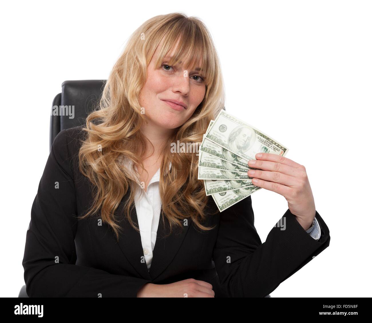 Successful businesswoman fanning herself with a fistful of money ...