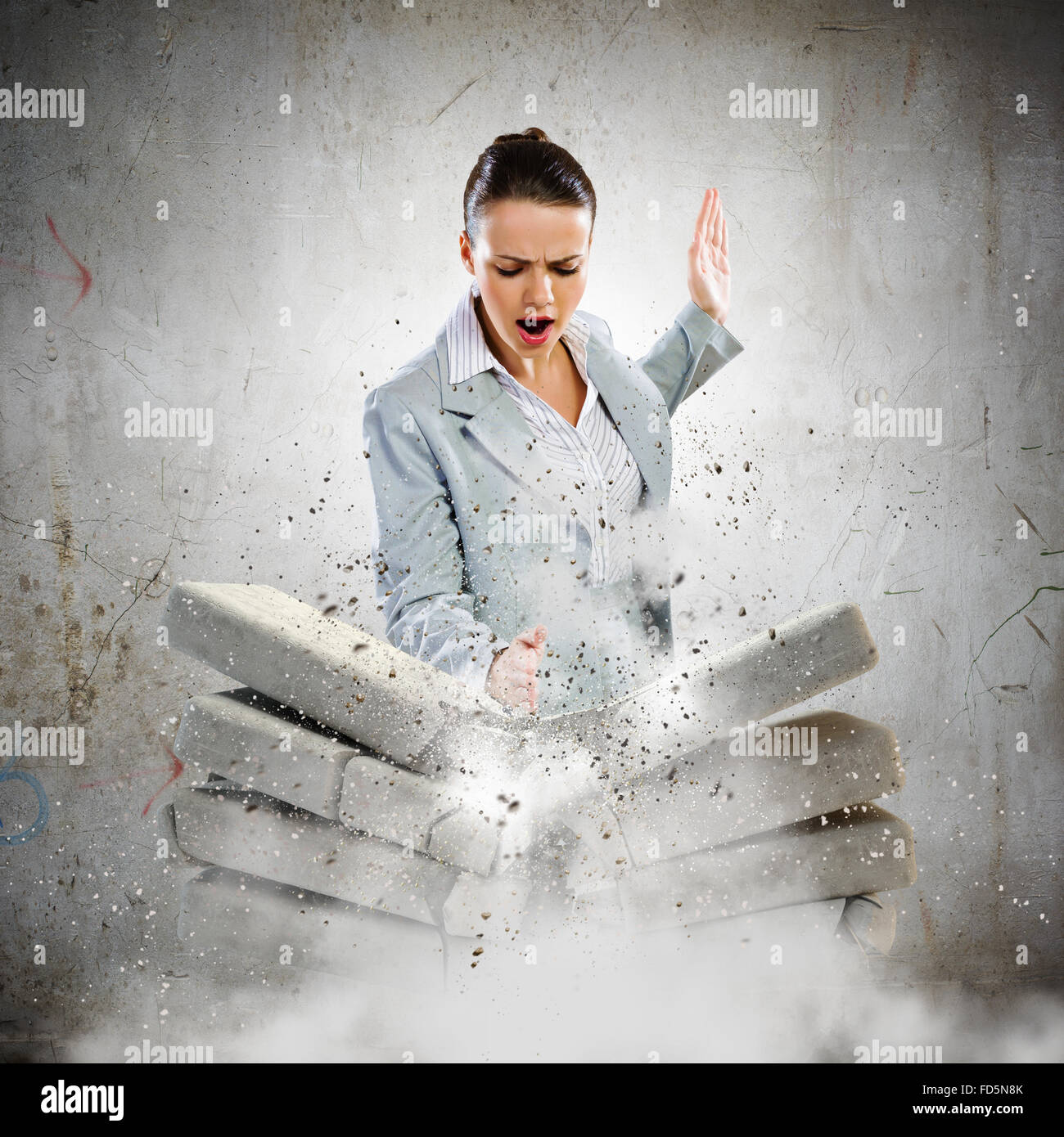 Image of businesswoman breaking bricks with hand Stock Photo - Alamy