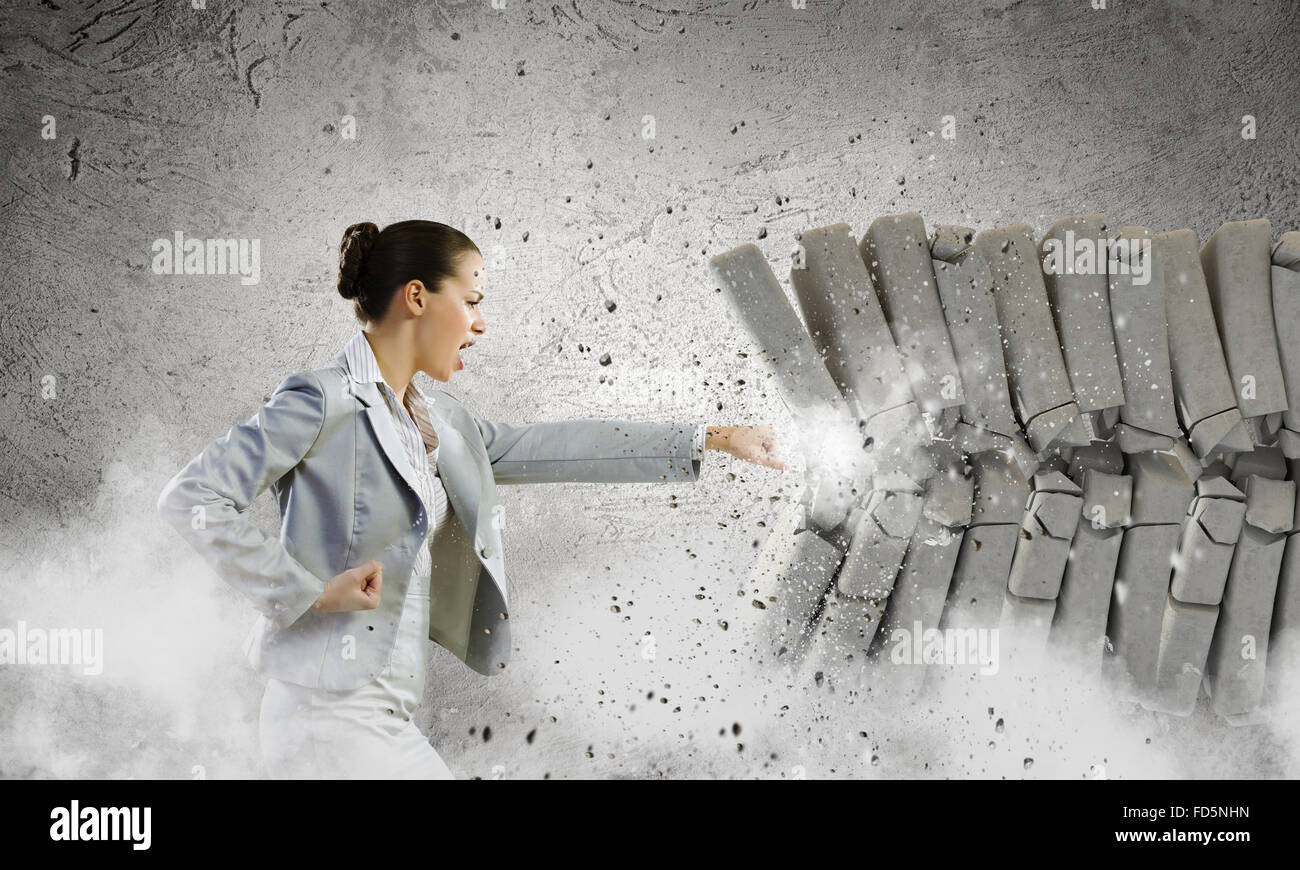 Image of businesswoman breaking bricks with hand Stock Photo - Alamy