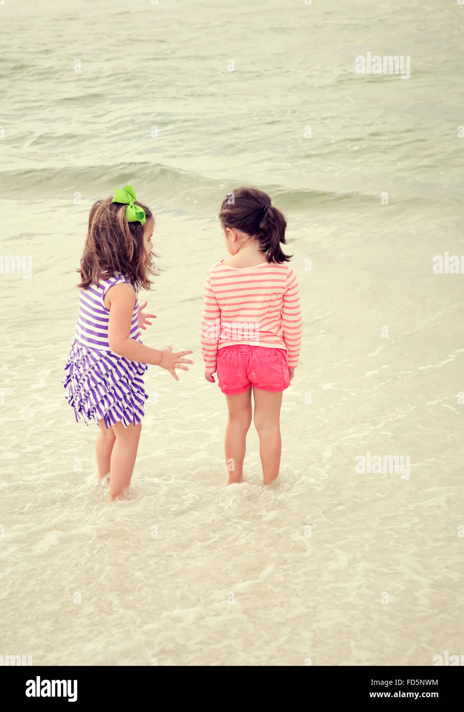 Two little girls talking hi-res stock photography and images - Alamy