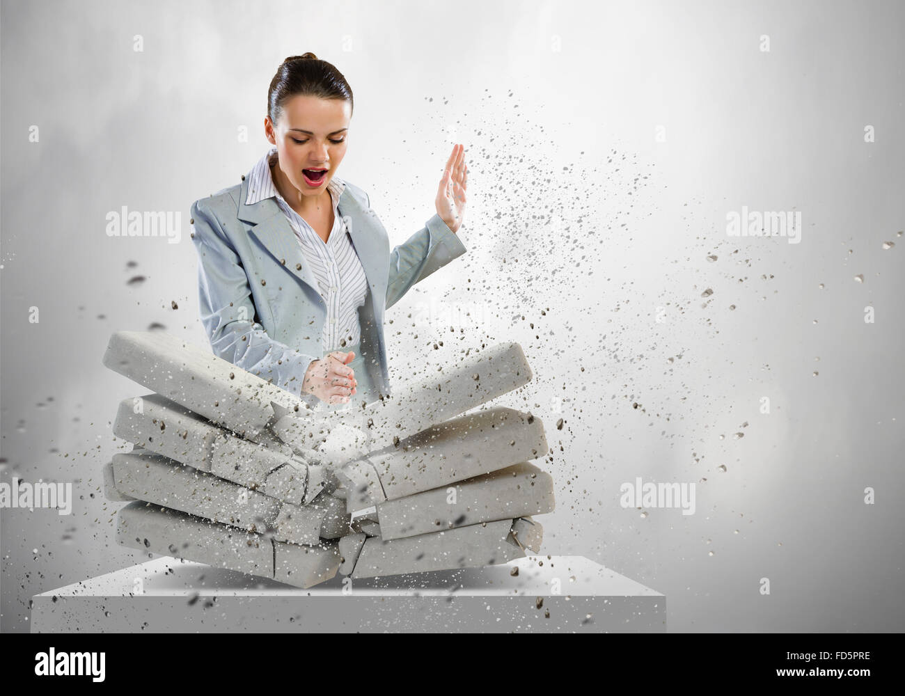 Image of businesswoman breaking bricks with hand Stock Photo - Alamy