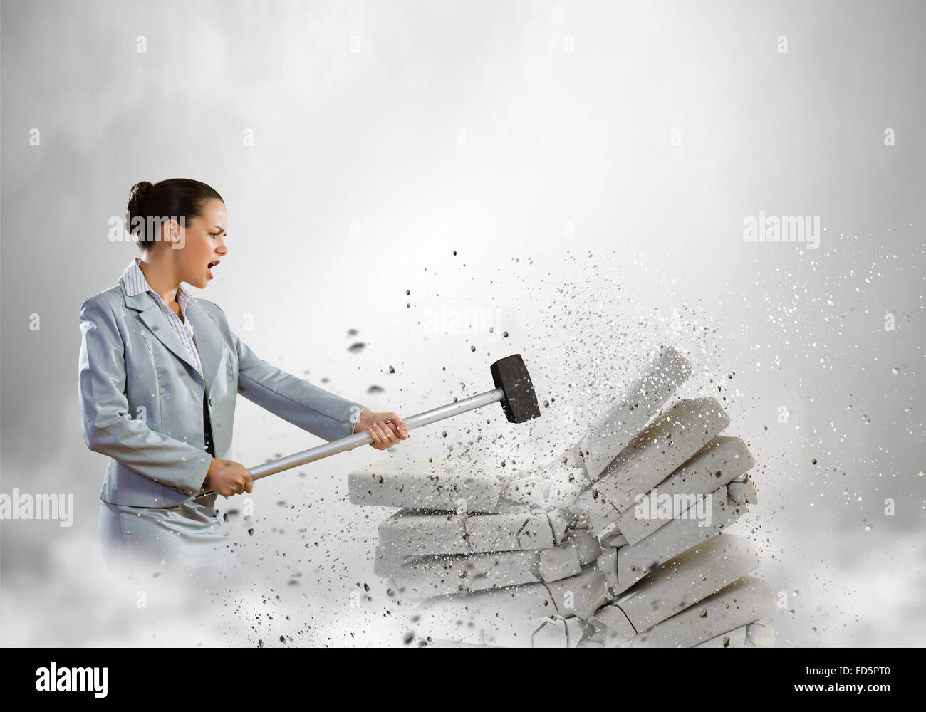 Image of businesswoman breaking bricks with hammer Stock Photo - Alamy