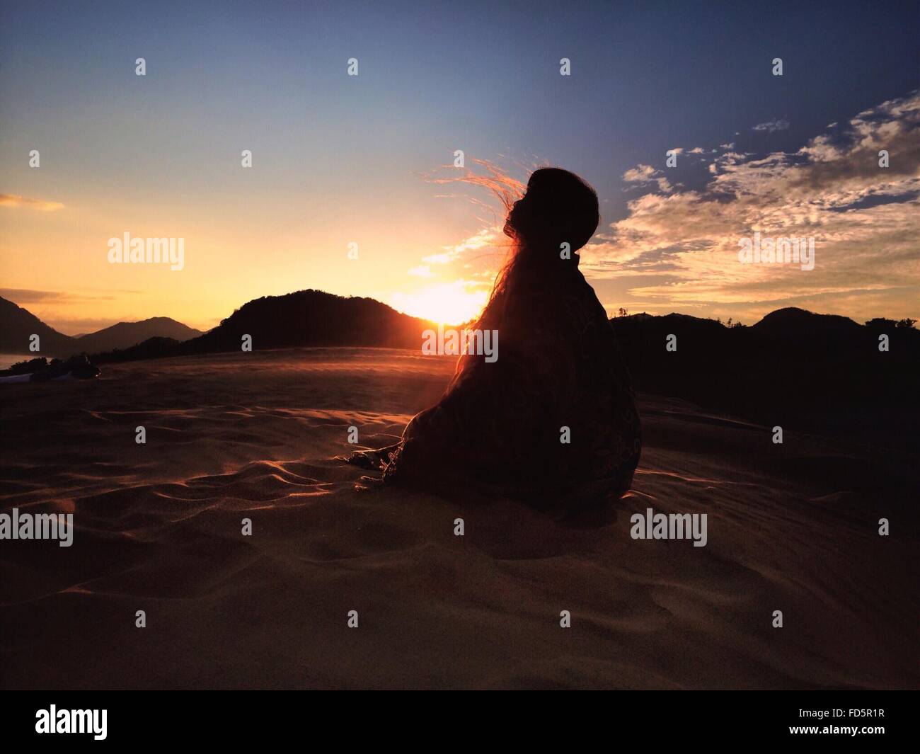 Girl Sitting On Sand Stock Photo - Alamy