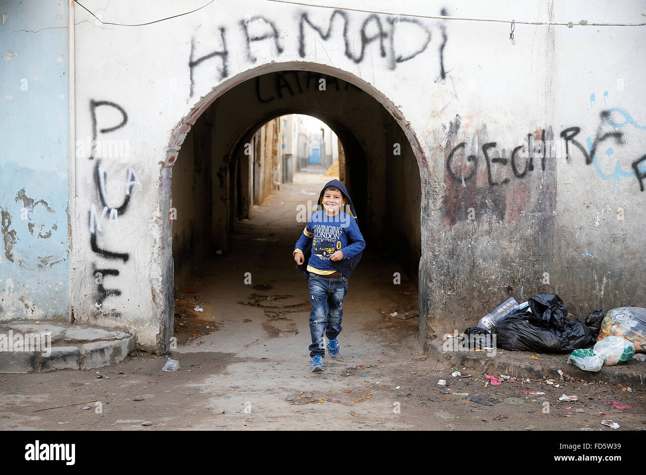 Boy running in a street of Halfaouine Stock Photo - Alamy