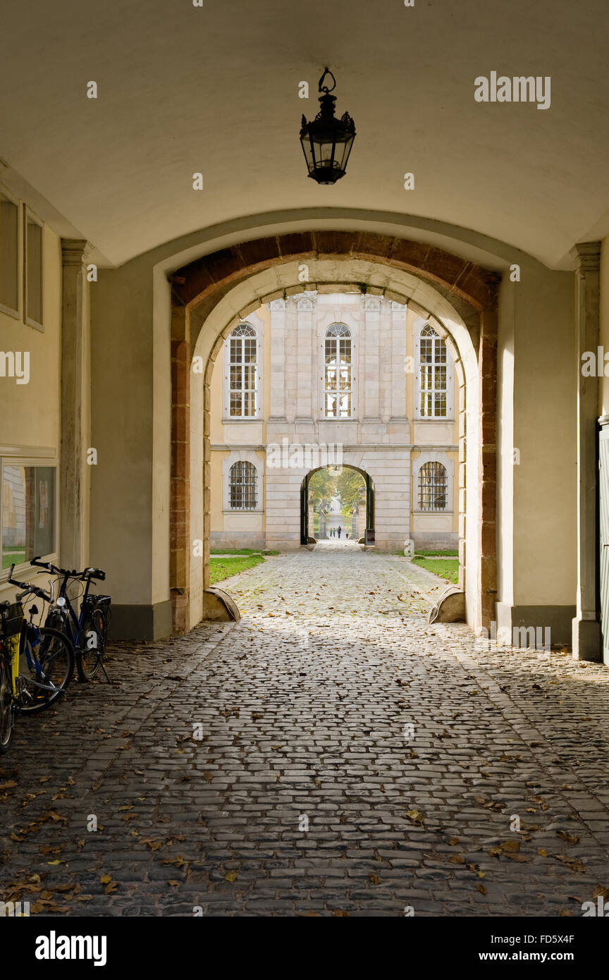 View through baroque gatehouse with cobbled driveway Fasanerie castle ...