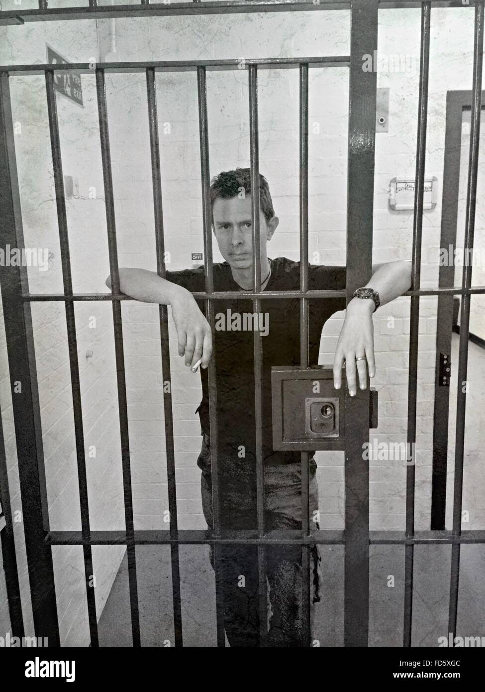 Prisoner smoking cigarette cell hi-res stock photography and images - Alamy
