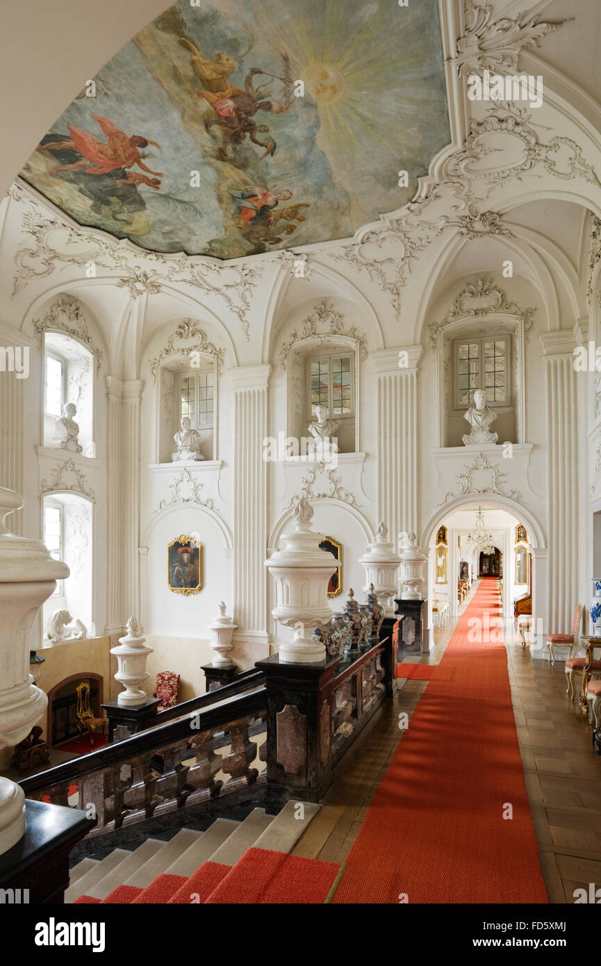 Rococo stucco ceiling above grand staircase and corridor with red ...