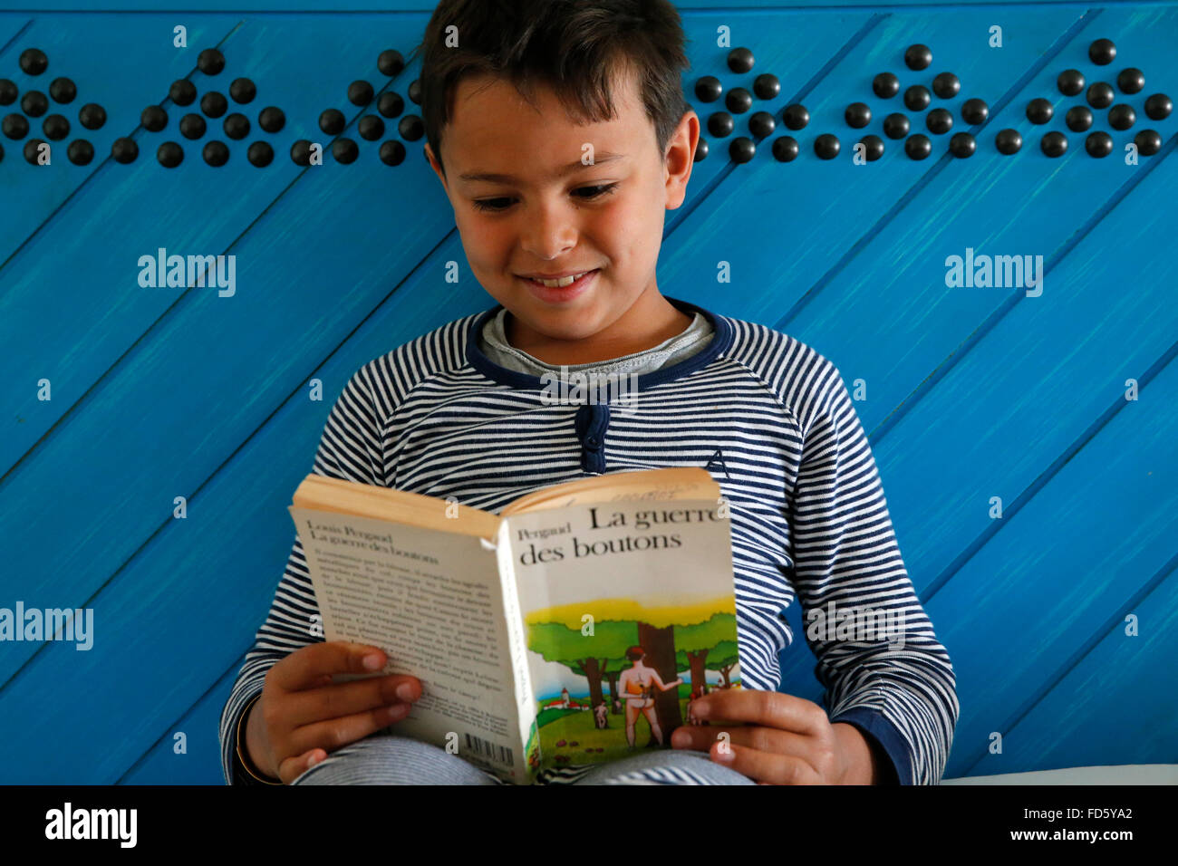 8-year-old boy reading a book Stock Photo - Alamy
