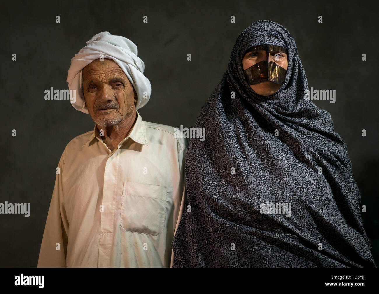 a bandari woman wearing a traditional mask called the burqa with her ...