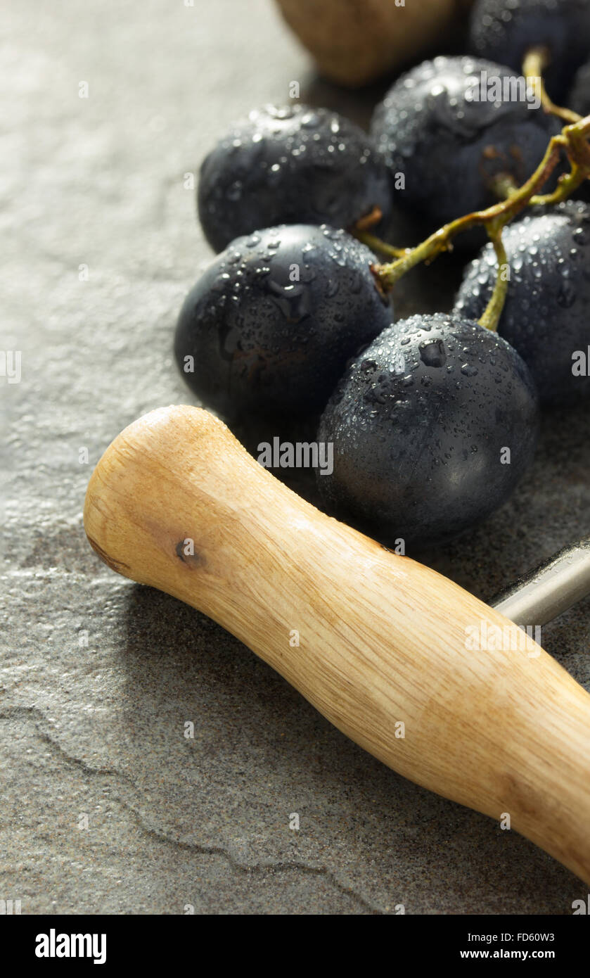 corkscrew and grape on table Stock Photo - Alamy