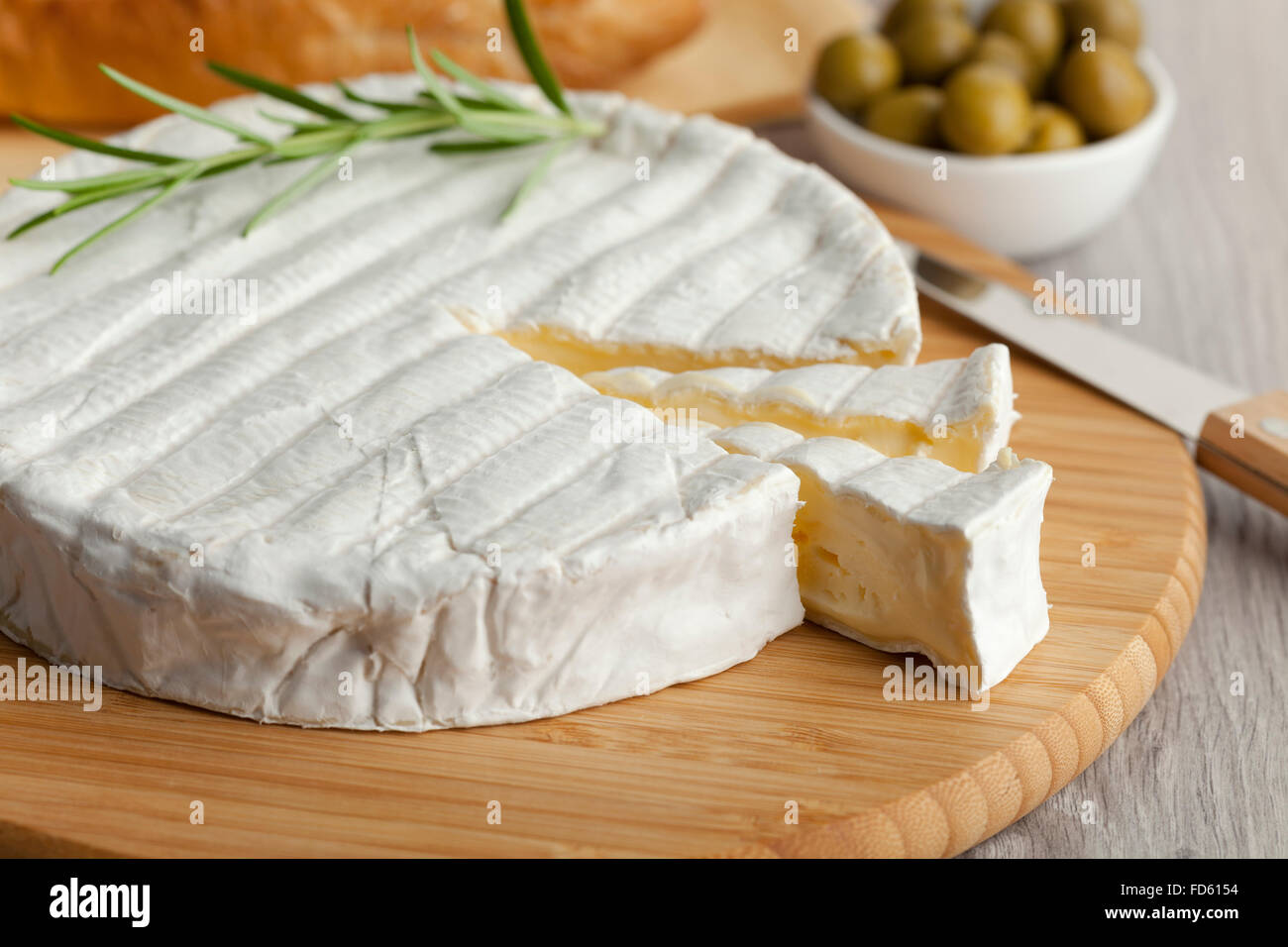 Fresh French Brie cheese and a slice Stock Photo - Alamy