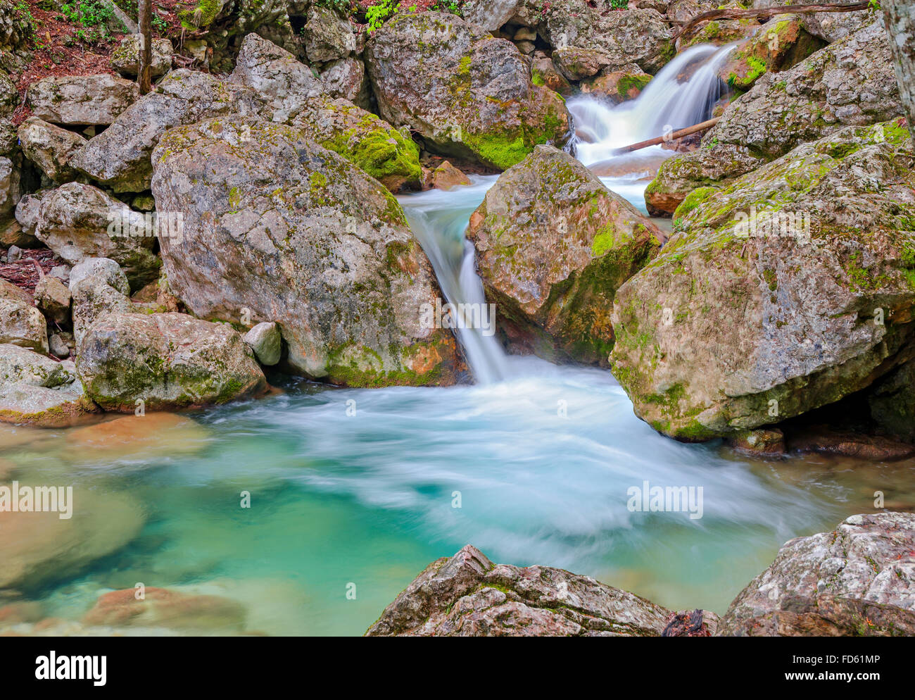 Waterfall in the spring forest. Flow of the spring melt water flowing ...