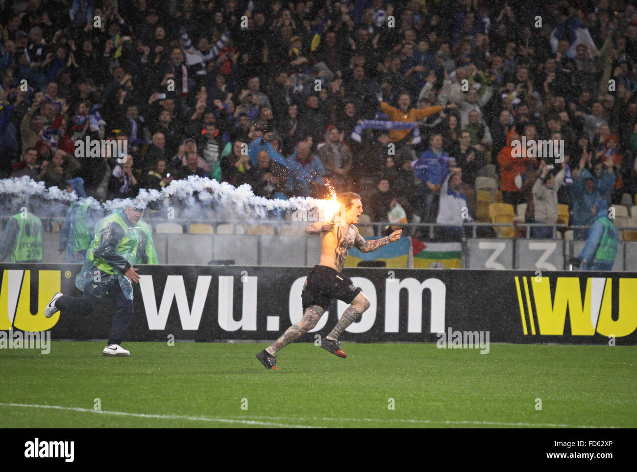 FC Dnipro ultra supporter runs out into the pitch with flare to ...
