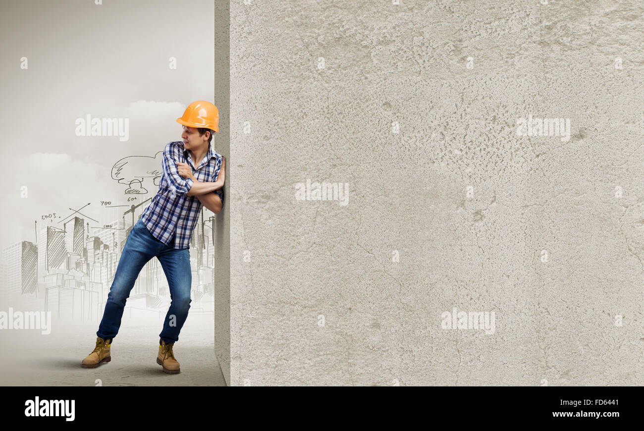 Image of man engineer leaning on wall. Construction concept Stock Photo ...