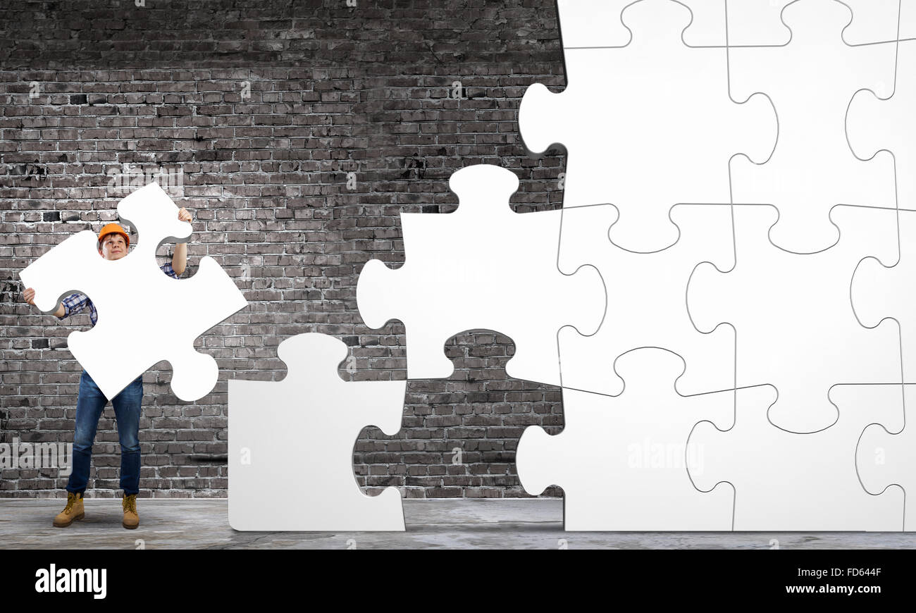 Image of man engineer connecting puzzle elements. Construction concept ...