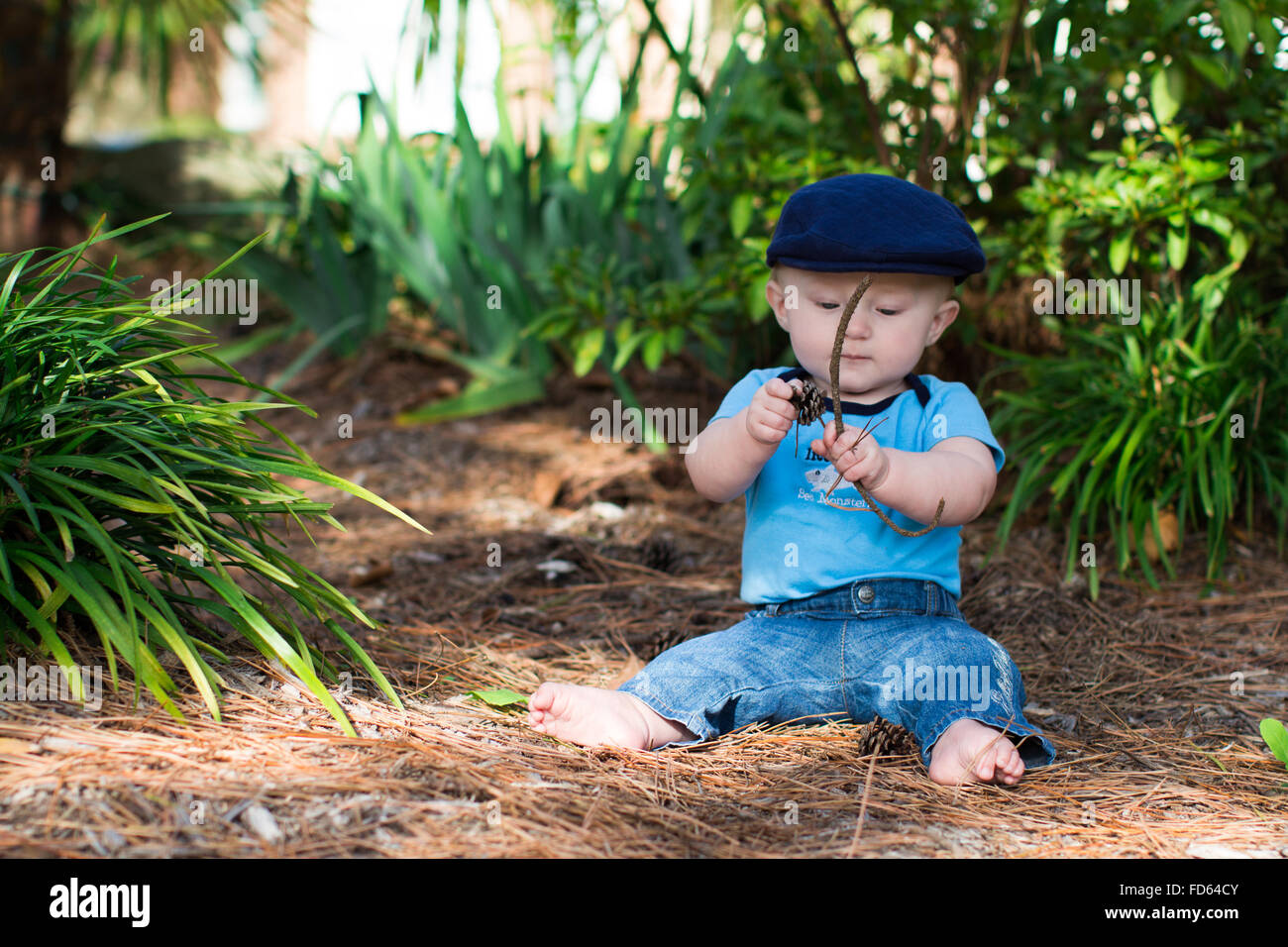 Baby Boy Playing With Sticks Stock Photo - Alamy