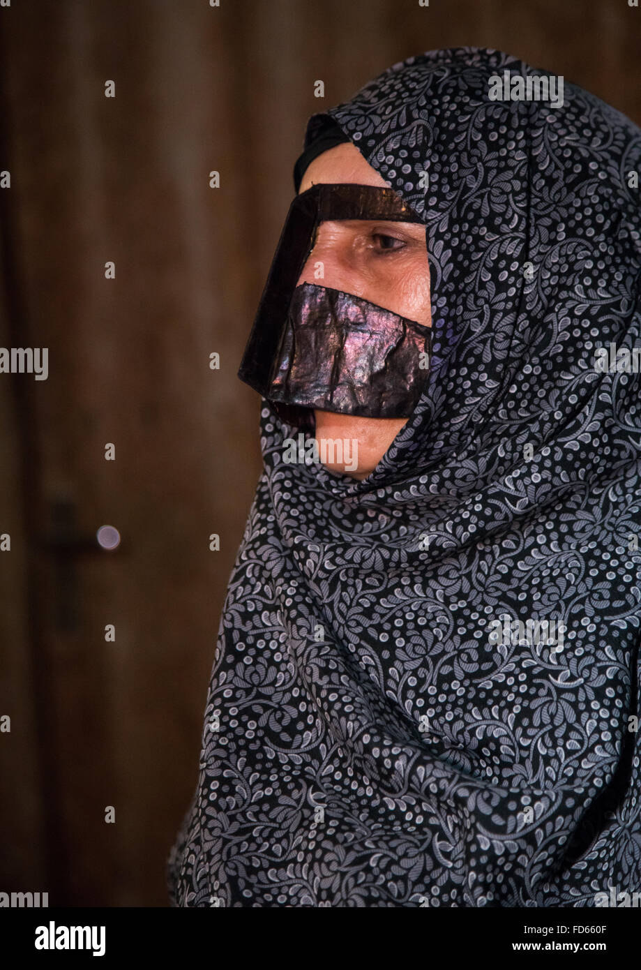 a bandari woman wearing a traditional mask called the burqa, Qeshm ...