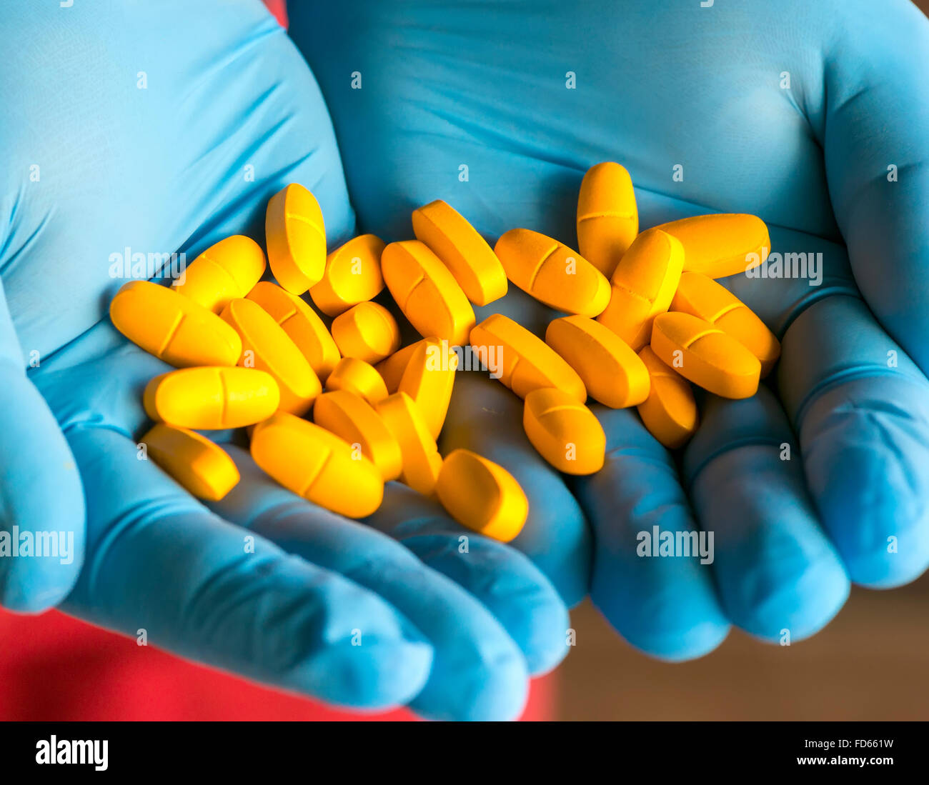 closeup of female hands with blue gloves and pills capsules Stock Photo ...