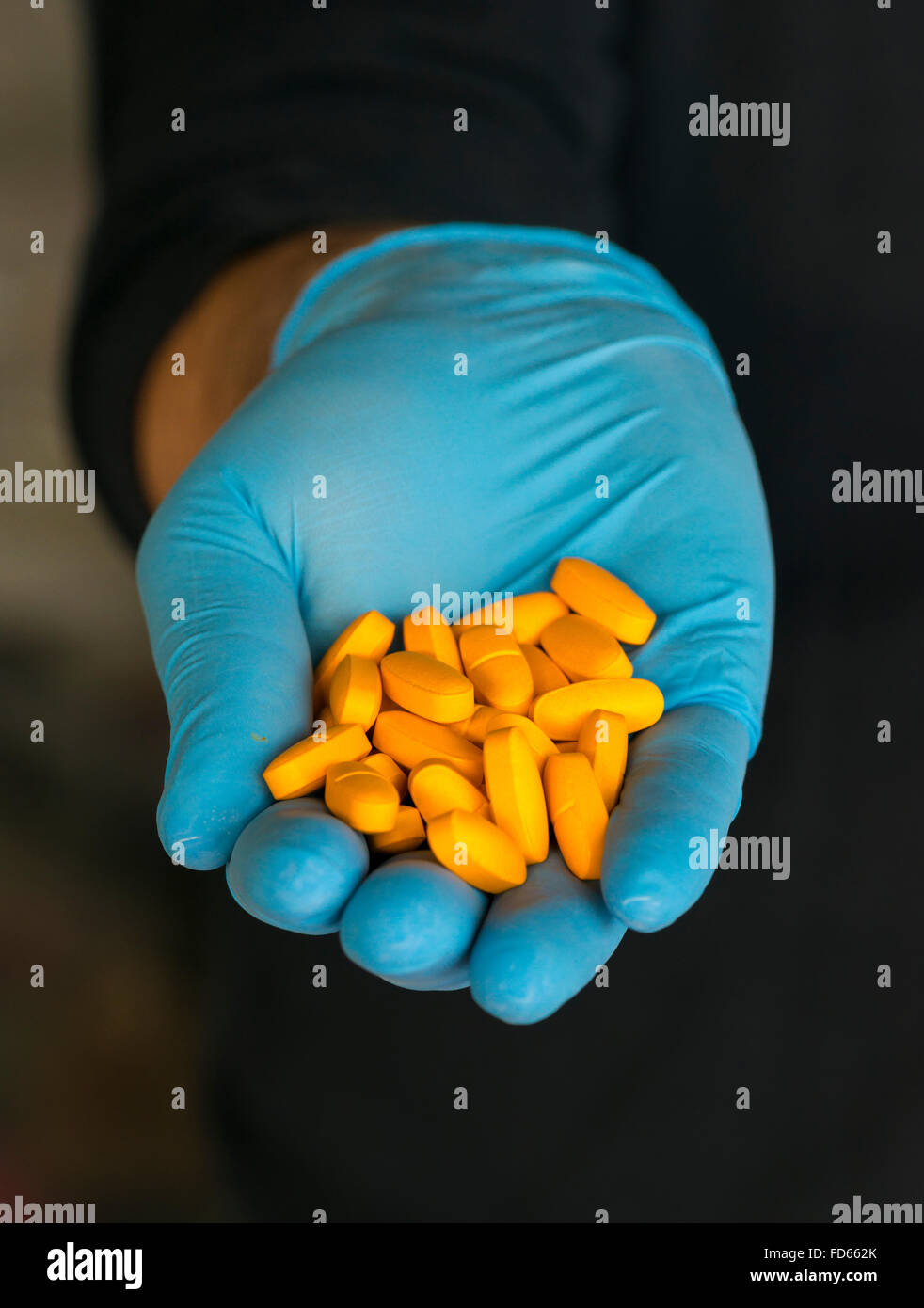 closeup of male hand with blue glove and pills capsules Stock Photo - Alamy