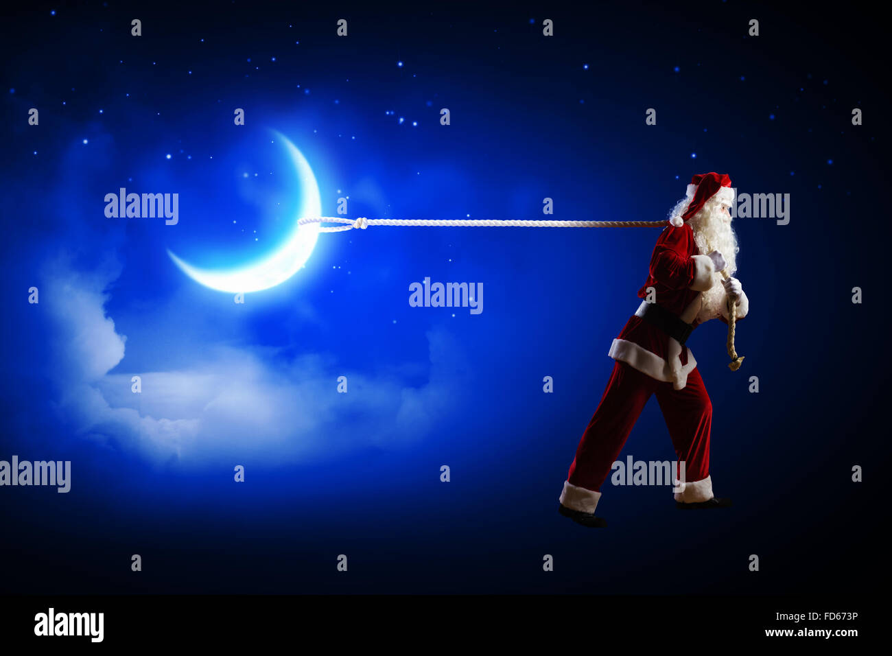 Image of Santa Claus pulling moon with rope Stock Photo - Alamy