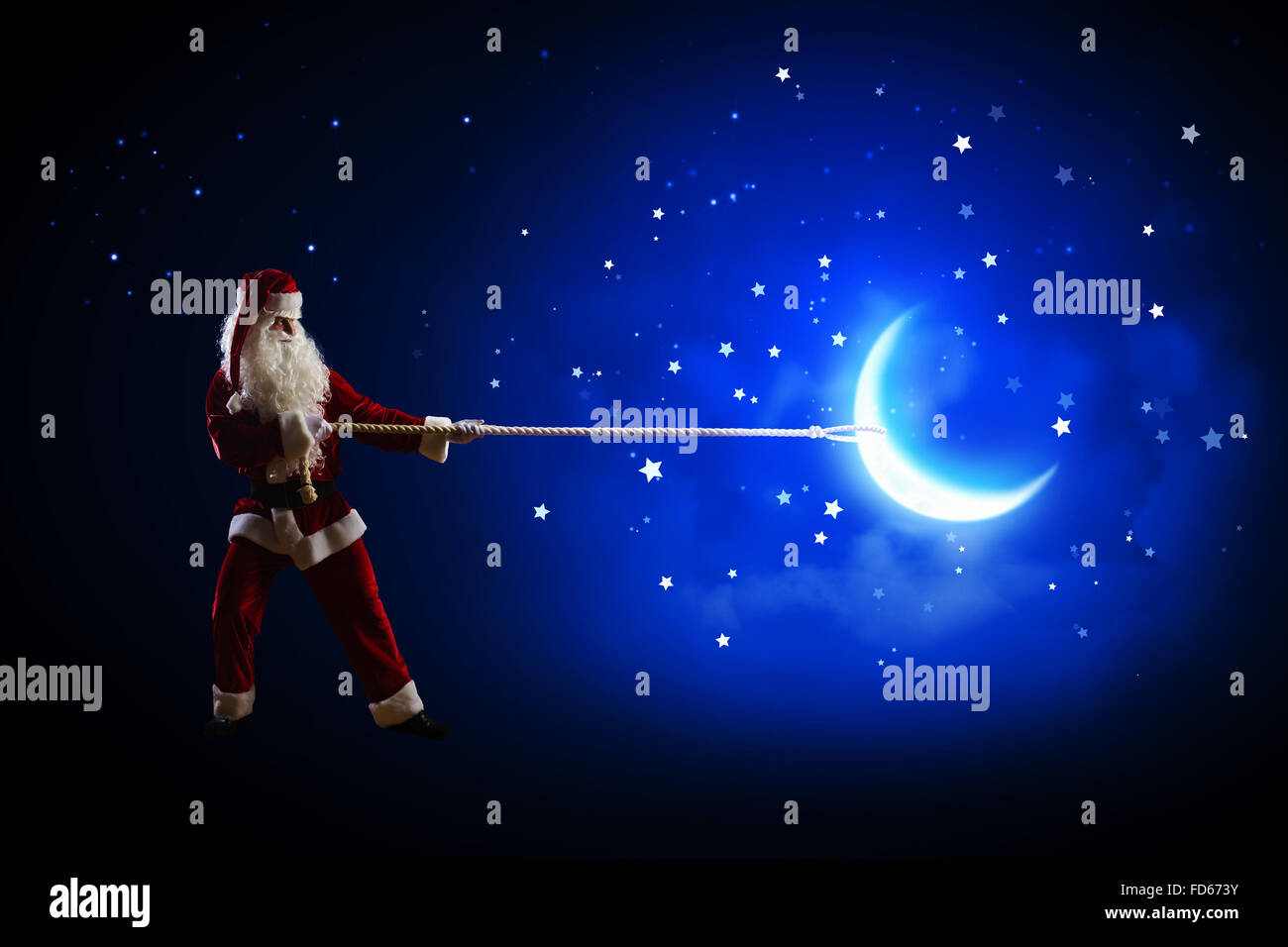 Image of Santa Claus pulling moon with rope Stock Photo - Alamy