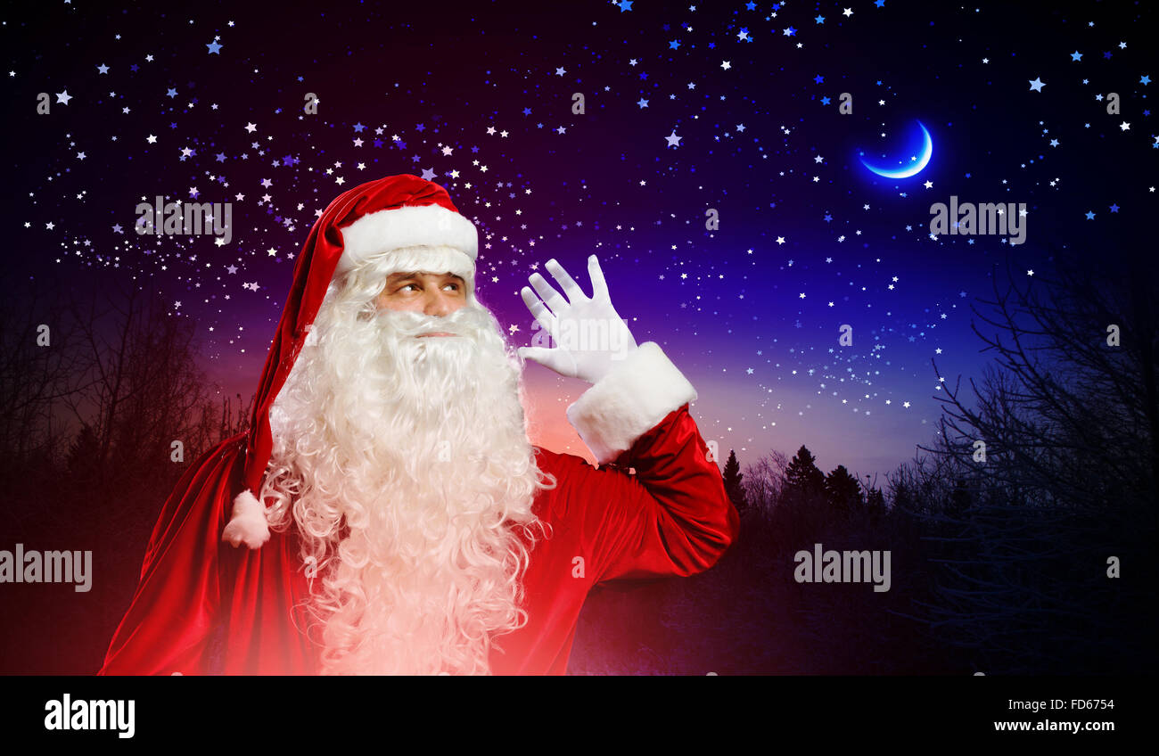 Image of Santa Claus against night sky background Stock Photo - Alamy