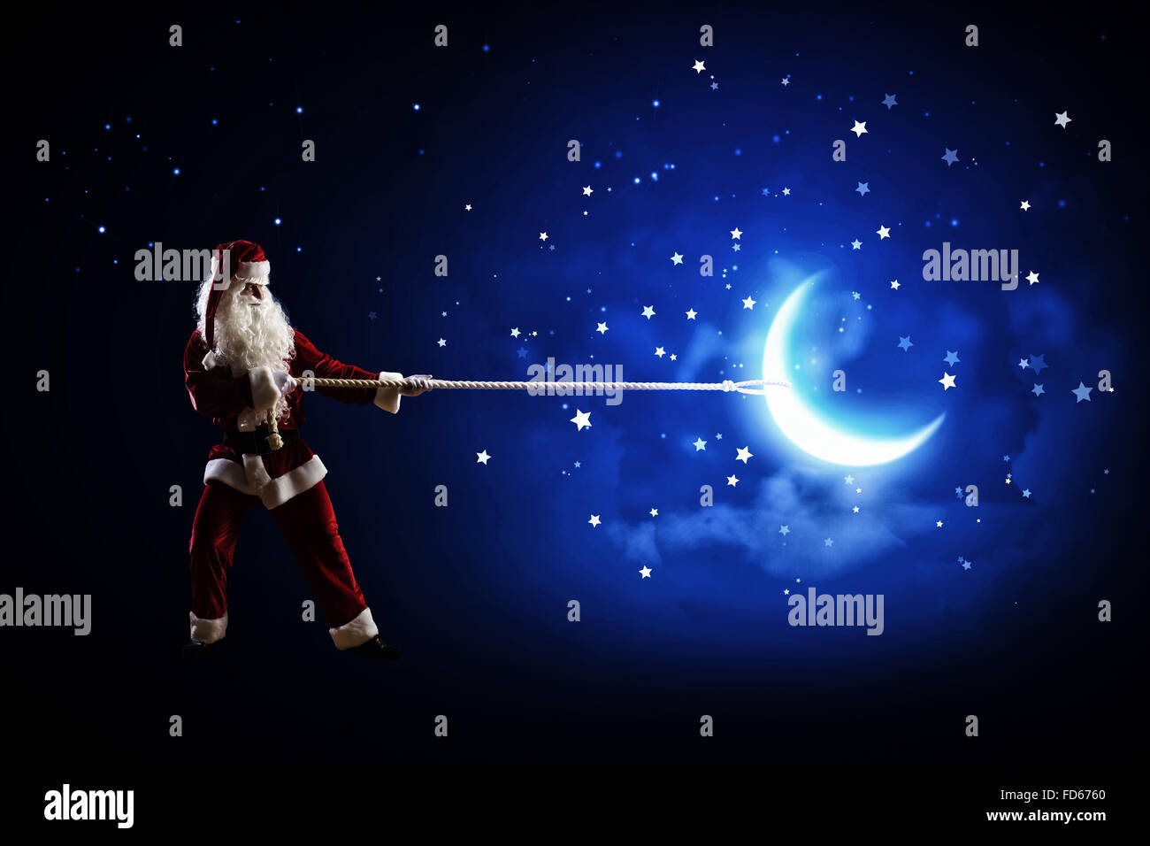 Image of Santa Claus pulling moon with rope Stock Photo - Alamy