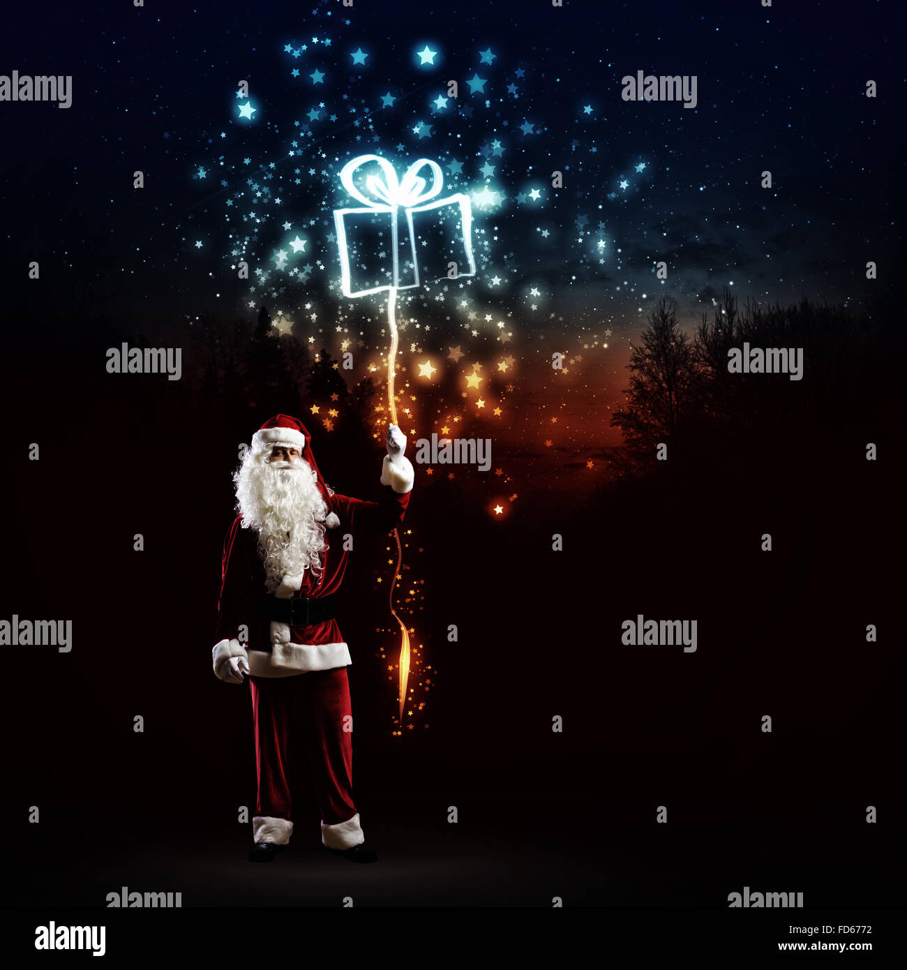 Image of Santa Claus with present against dark background Stock Photo ...