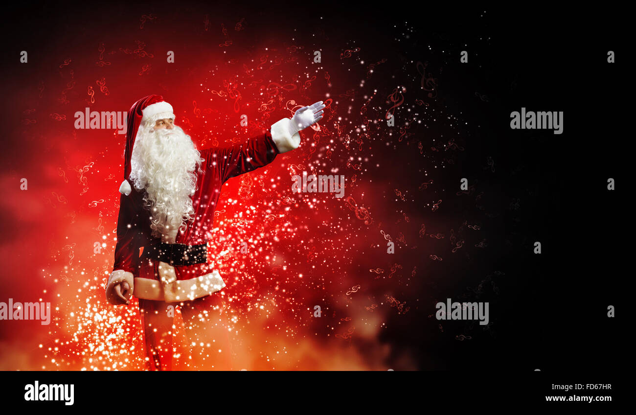 Image of Santa Claus in red costume against dark background Stock Photo ...