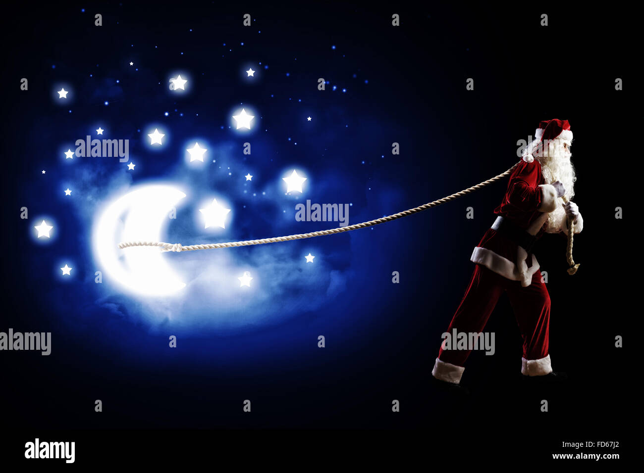 Image of Santa Claus pulling moon with rope Stock Photo - Alamy