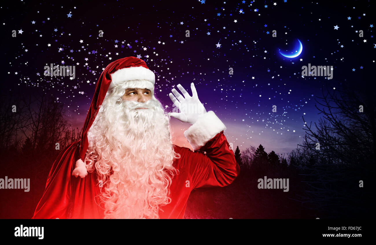 Image of Santa Claus against night sky background Stock Photo - Alamy