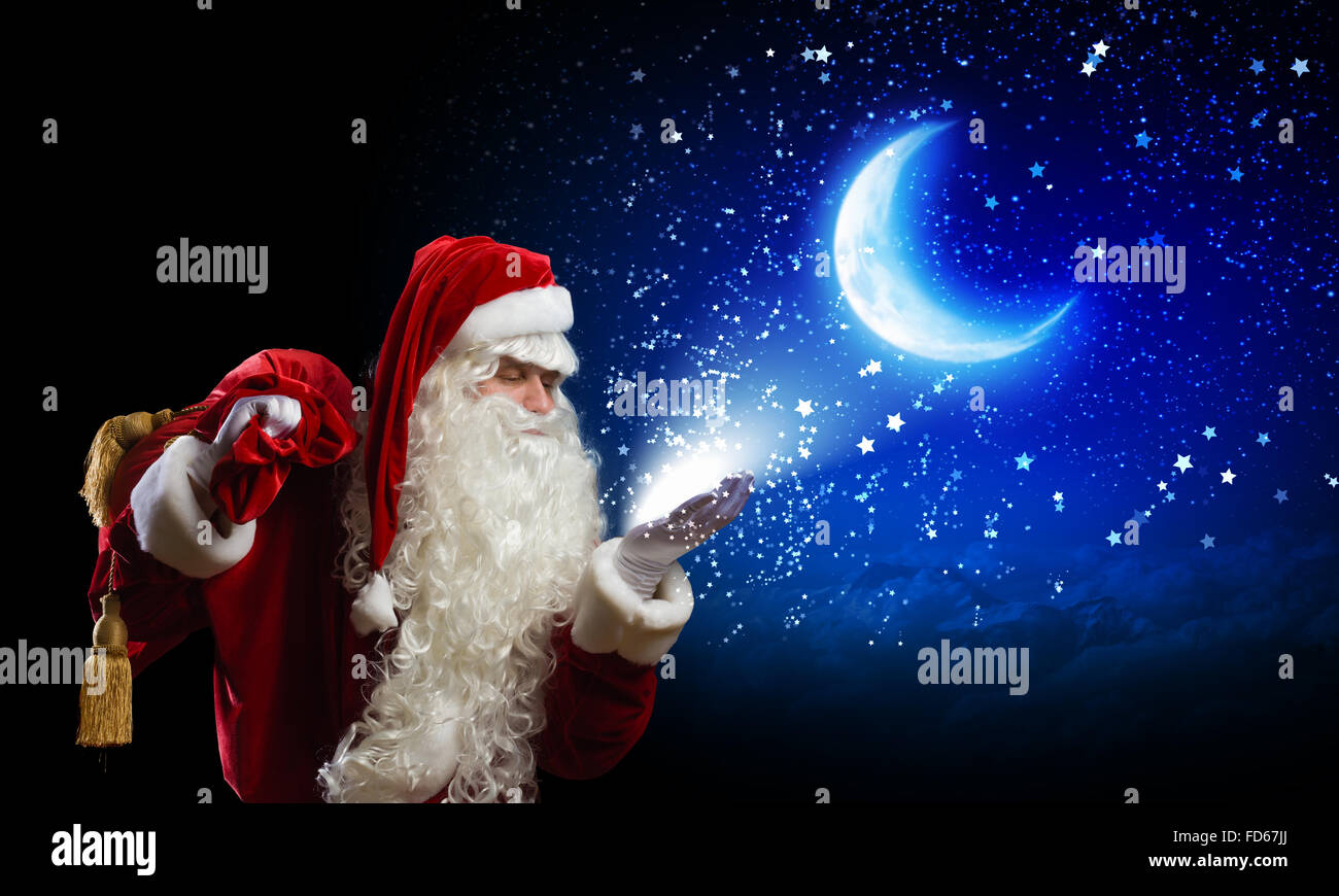 Image of Santa Claus against night sky background Stock Photo - Alamy