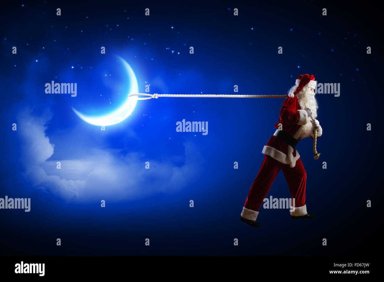 Image of Santa Claus pulling moon with rope Stock Photo - Alamy