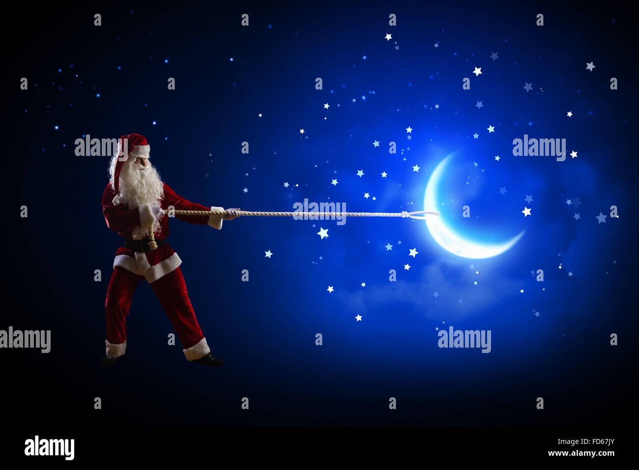 Image of Santa Claus pulling moon with rope Stock Photo - Alamy