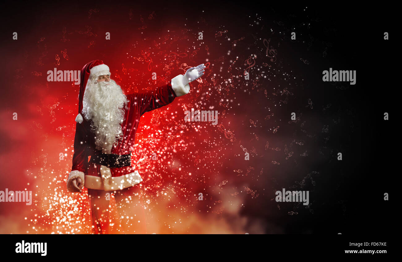 Image of Santa Claus in red costume against dark background Stock Photo ...