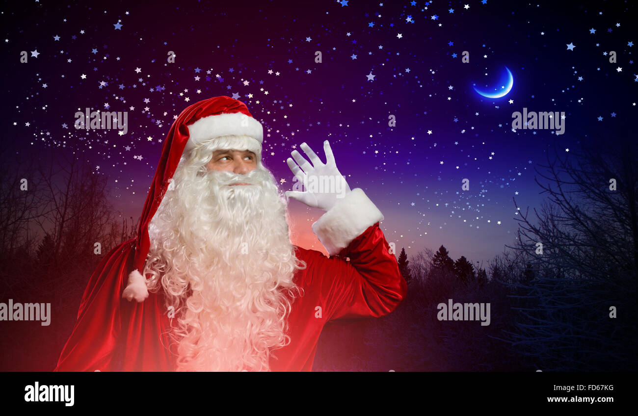Image of Santa Claus against night sky background Stock Photo - Alamy