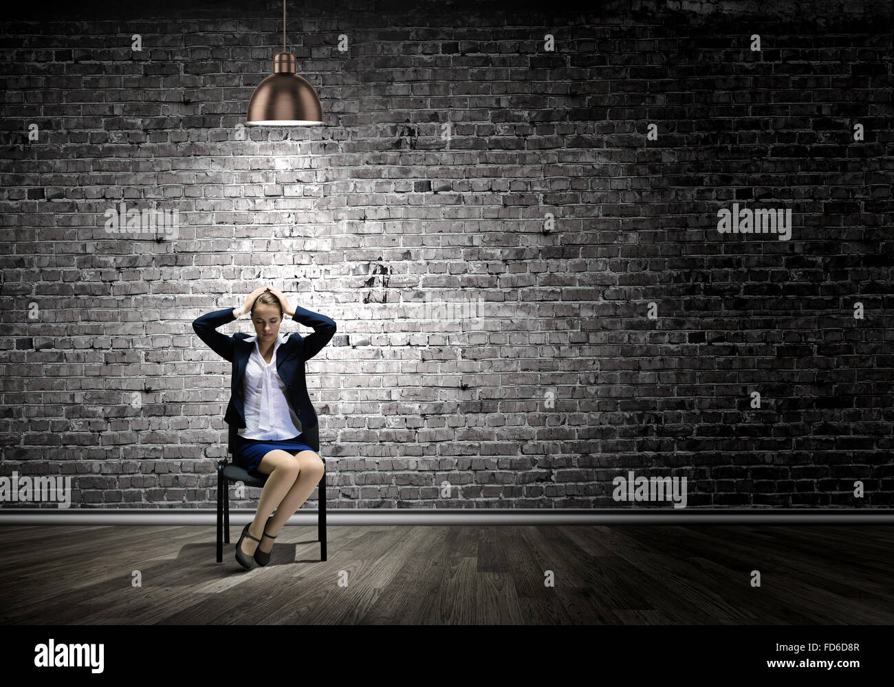 Image of young businesswoman sitting on chair under spot of light Stock ...