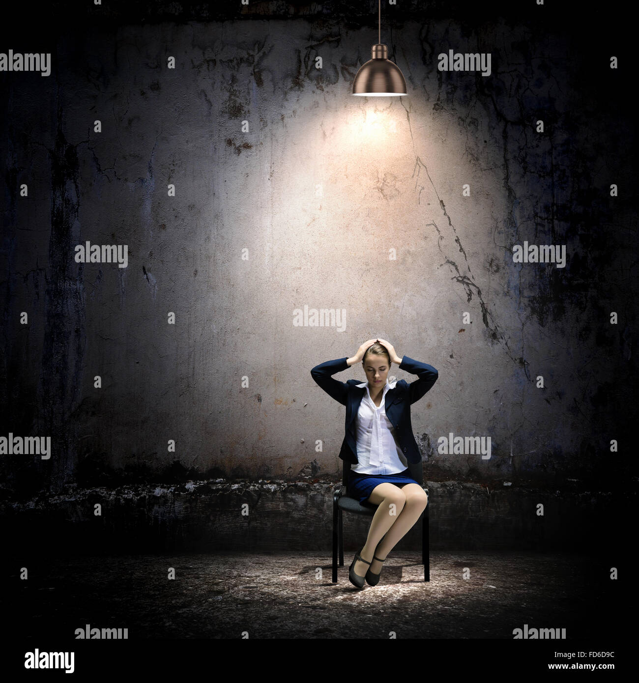 Image of young businesswoman sitting on chair under spot of light Stock ...