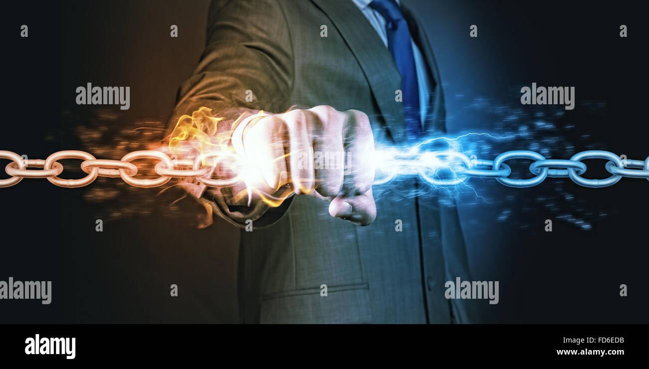 Powerful businessman holding chain in his fist Stock Photo - Alamy