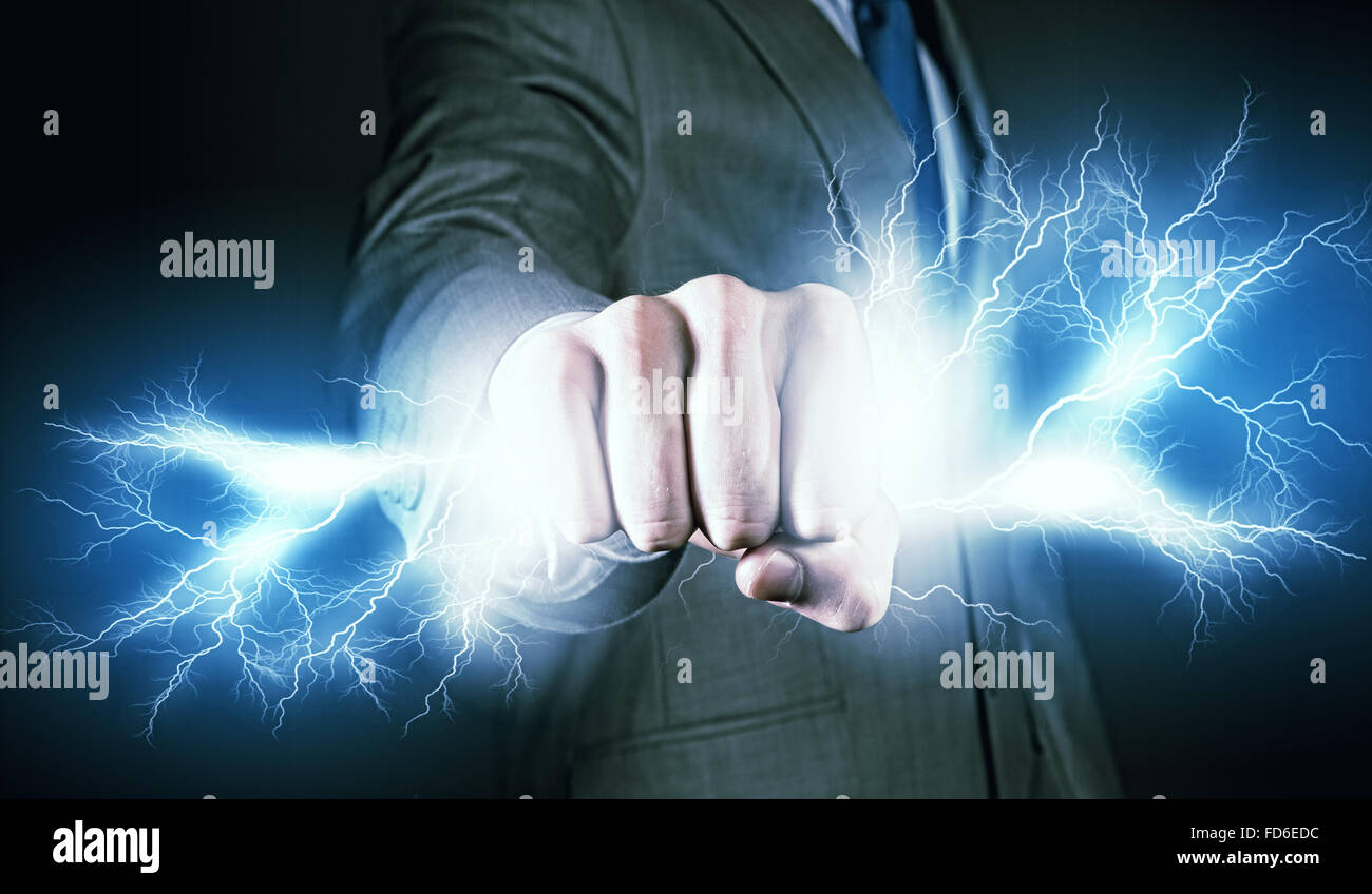 Businessman holding lightning in fist. Power and control Stock Photo ...