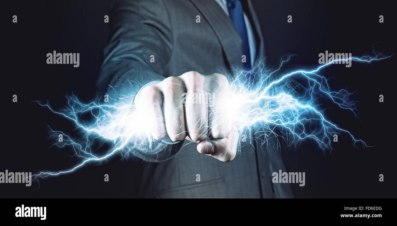 Businessman holding lightning in fist. Power and control Stock Photo ...