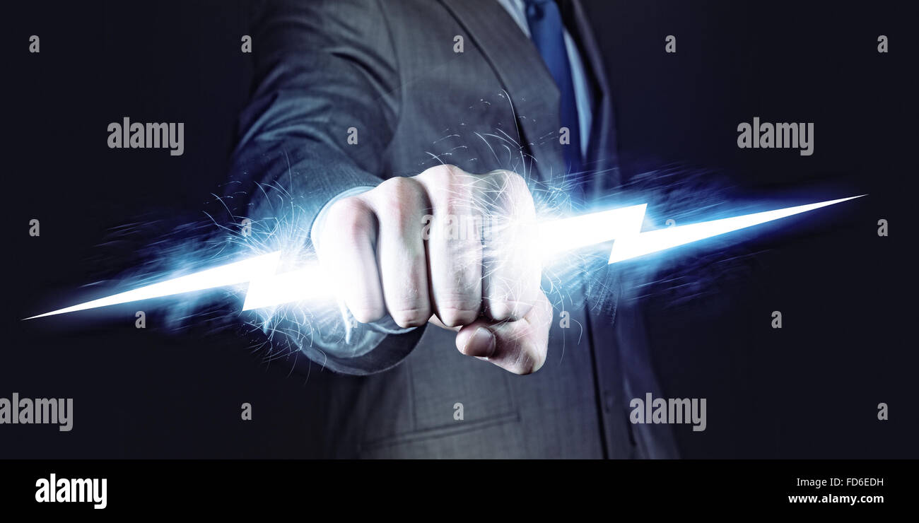 Businessman holding lightning in fist. Power and control Stock Photo ...