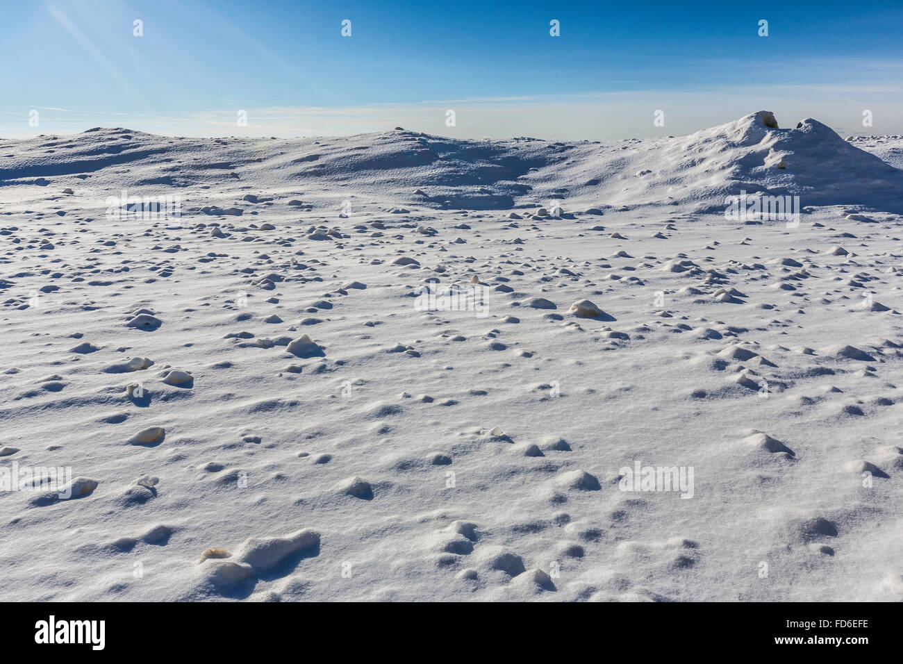 Ice balls, now covered with snow, formed in the surf, then frozen solid ...
