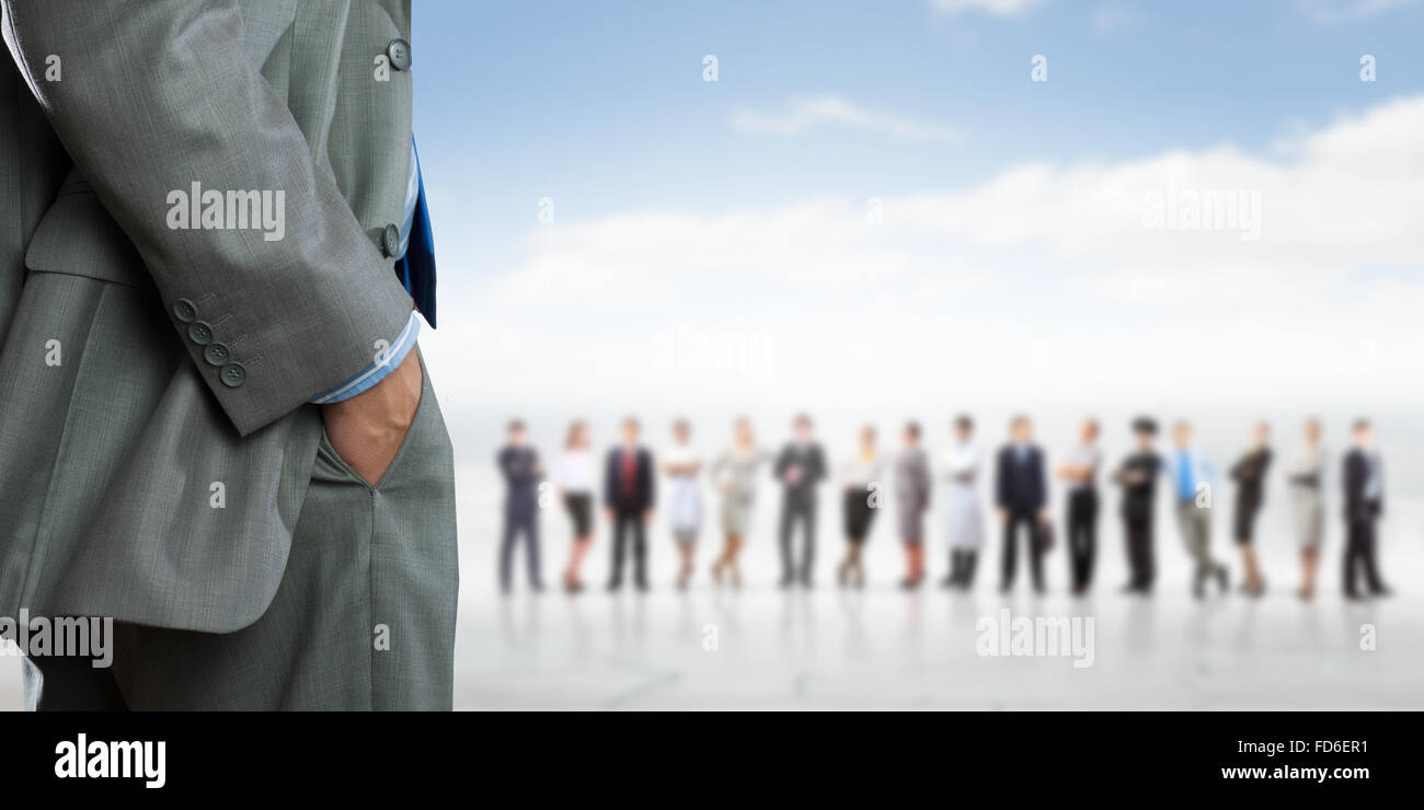 Bottom image of businessman with people at background Stock Photo - Alamy